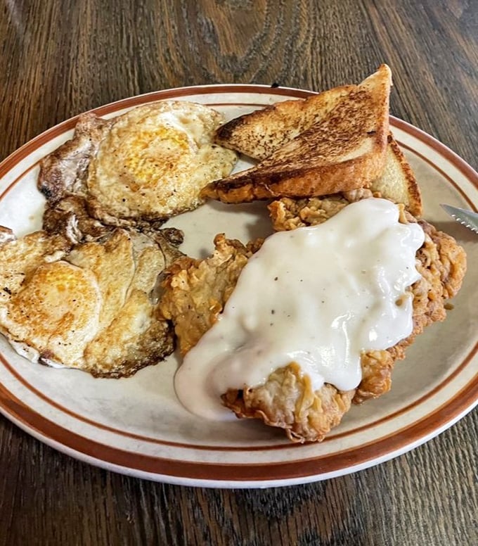 The chicken fried steak with gravy arrives like the headliner it is, flanked by golden eggs and toast – breakfast doesn't get more Texan than this.