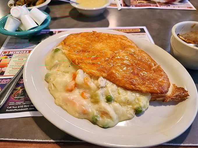 Comfort food perfection: golden puff pastry floating atop a sea of creamy chicken and vegetables. Like a warm hug from your grandmother, if she were a culinary genius.