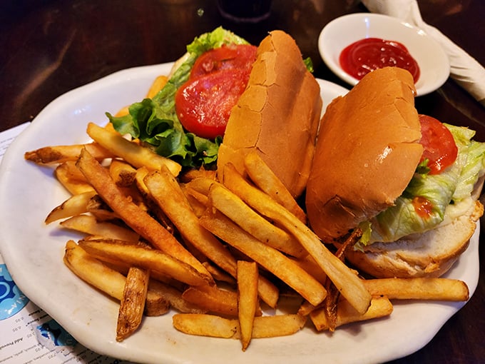 A sandwich that requires strategy to eat – crispy fries, fresh veggies, and a roll that's somehow both soft and sturdy. Napkins: not optional.