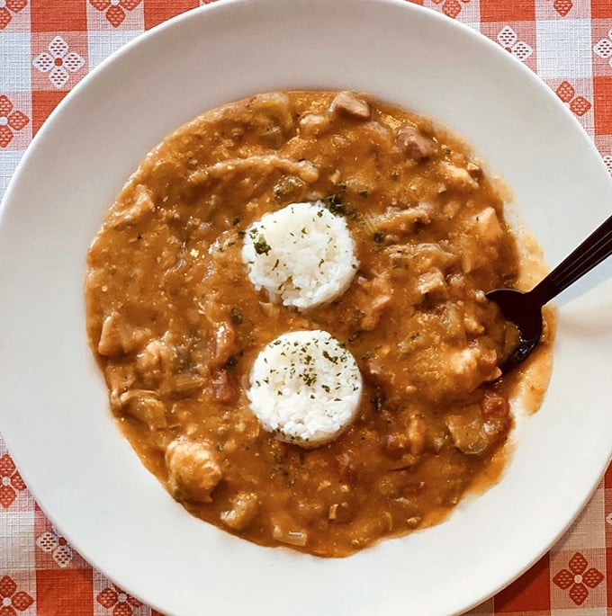 Two perfect rice islands rising from a sea of rich, hearty gumbo—proof that sometimes the best things come in unassuming bowls.