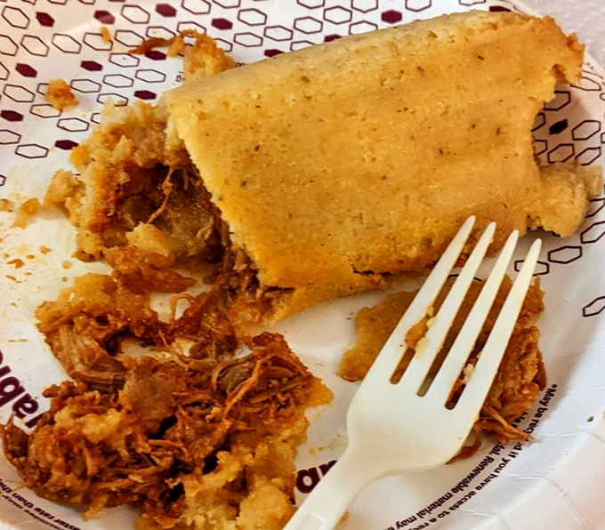 The moment of tamale truth—when that first bite reveals tender masa giving way to savory filling. This is what food dreams are made of.