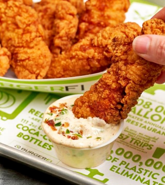 Golden-brown chicken tenders that actually taste like chicken – what a concept! Crispy outside, juicy inside, and that dipping sauce is calling your name. 