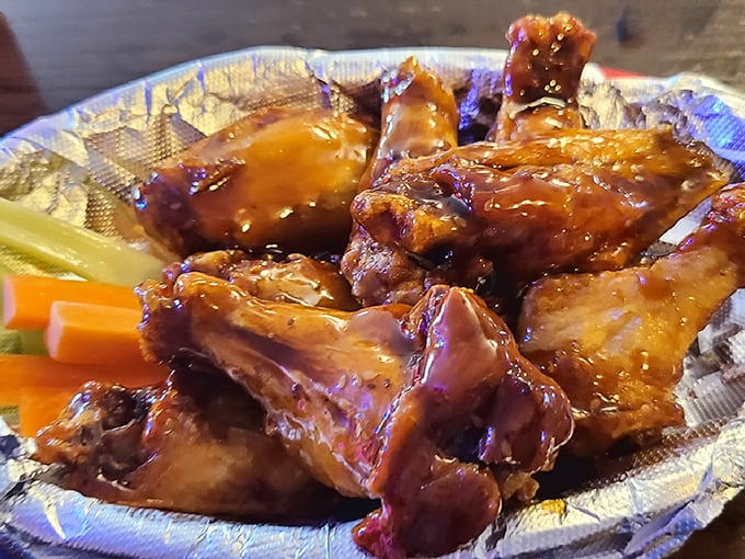 Wings glistening with sauce like they've been dipped in amber. Vegetables make a token appearance, knowing full well they're just supporting actors in this meaty drama.