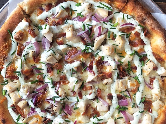 This chicken bacon ranch pizza isn't just a meal—it's a masterclass in balance, with perfectly blistered crust supporting a harmony of toppings and fresh herbs.