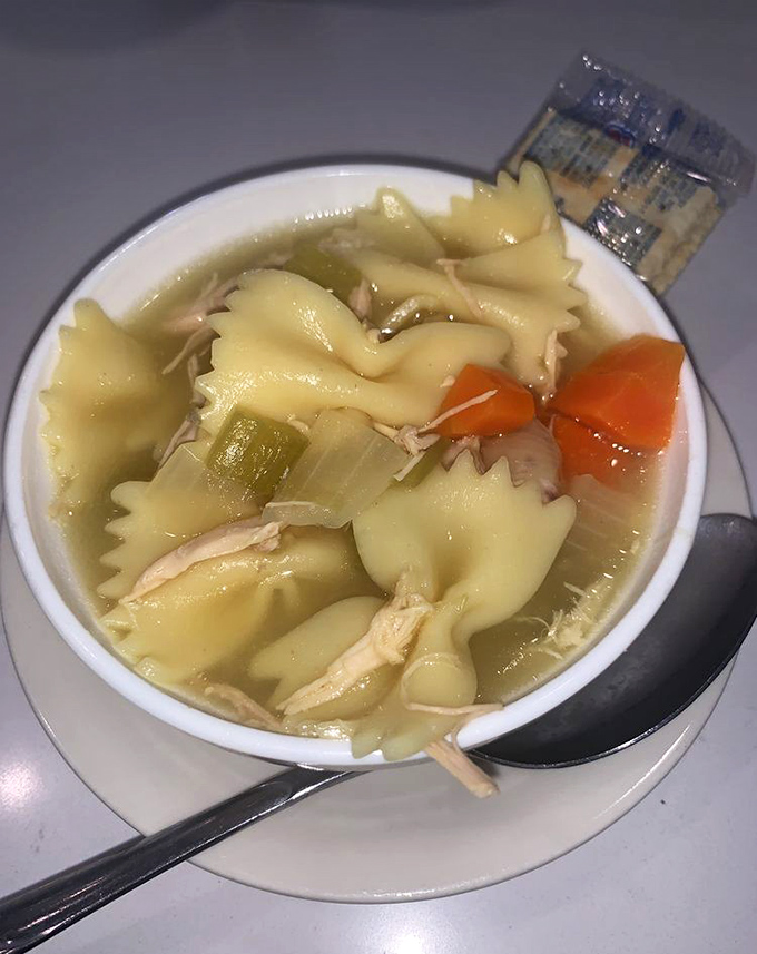 Chicken noodle soup that would make your grandmother nod in approval—simple, honest comfort swimming with bow-tie pasta and vegetables.