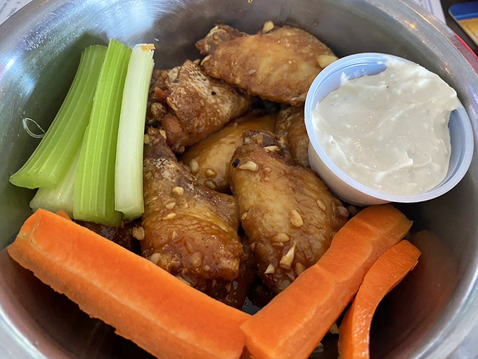 Whoever said chicken wings couldn't be sophisticated hasn't seen this presentation—crispy morsels accompanied by garden-fresh veggies and house-made dip.