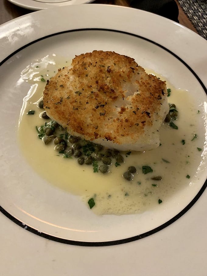 This Chilean Sea Bass is having a better spa day than most humans—bathed in butter, caressed with capers, and pampered with fresh herbs.