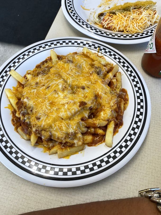 Chili cheese fries: where diet plans go to die gloriously. That melted cheese blanket covering savory chili and crispy fries is worth every napkin you'll need.