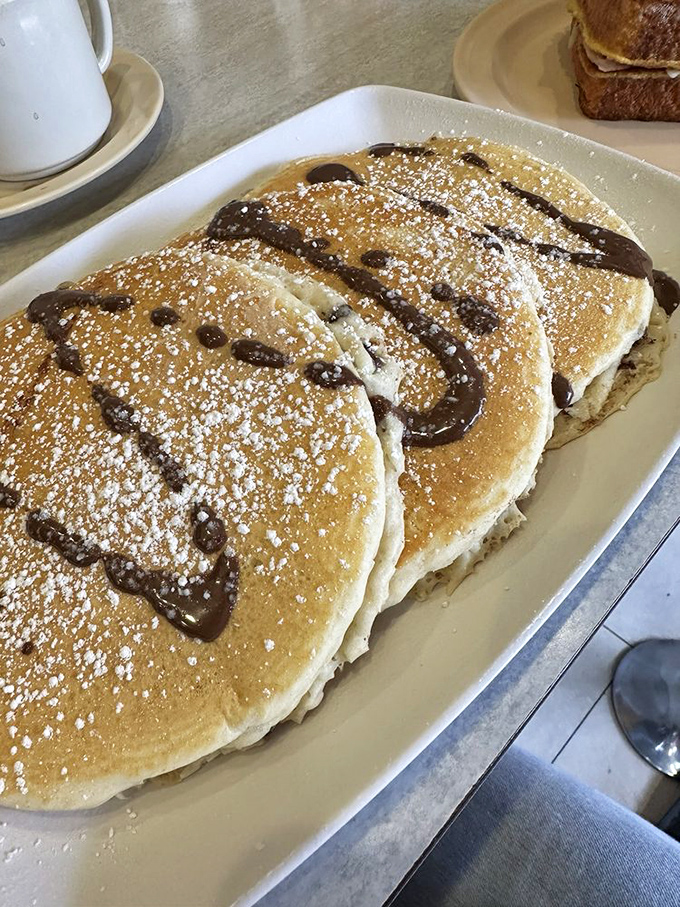 Chocolate chip pancakes dusted with powdered sugar—the breakfast equivalent of finding an extra twenty in your winter coat pocket.