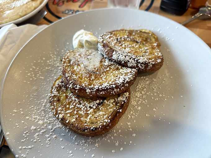 French toast that's had a cinnamon swirl makeover, dusted with powdered sugar and topped with fresh bananas—breakfast or dessert? The line deliciously blurs.