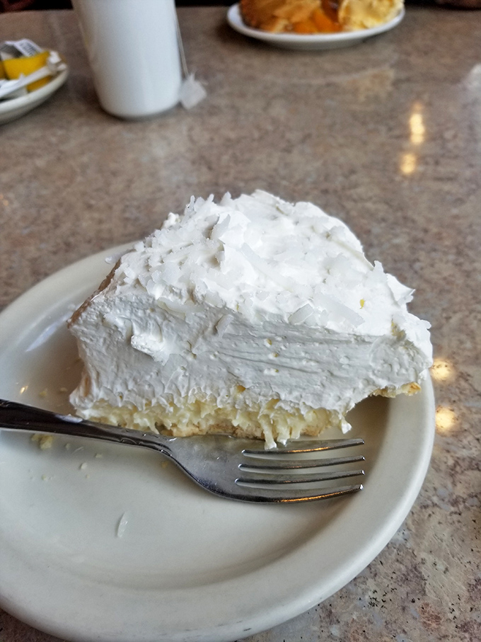 This coconut cream pie doesn't just have height—it has ambition. The meringue reaches for the stars while the filling stays grounded in deliciousness.
