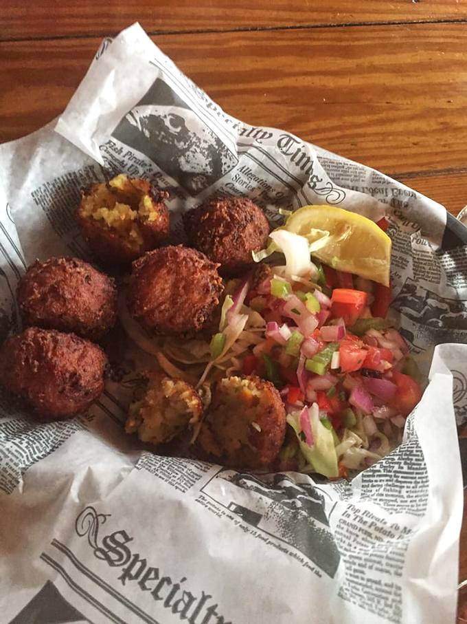 Conch fritters done right—crispy golden spheres of the sea, served with enough colorful slaw to make your Instagram followers weep with envy.