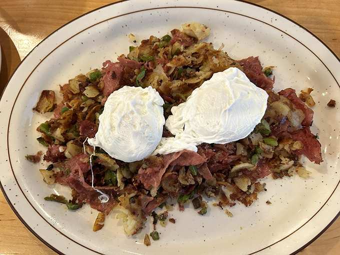 Corned beef hash topped with perfectly poached eggs—the breakfast equivalent of hitting the lottery. Those yolks are about to create a sauce that dreams are made of.