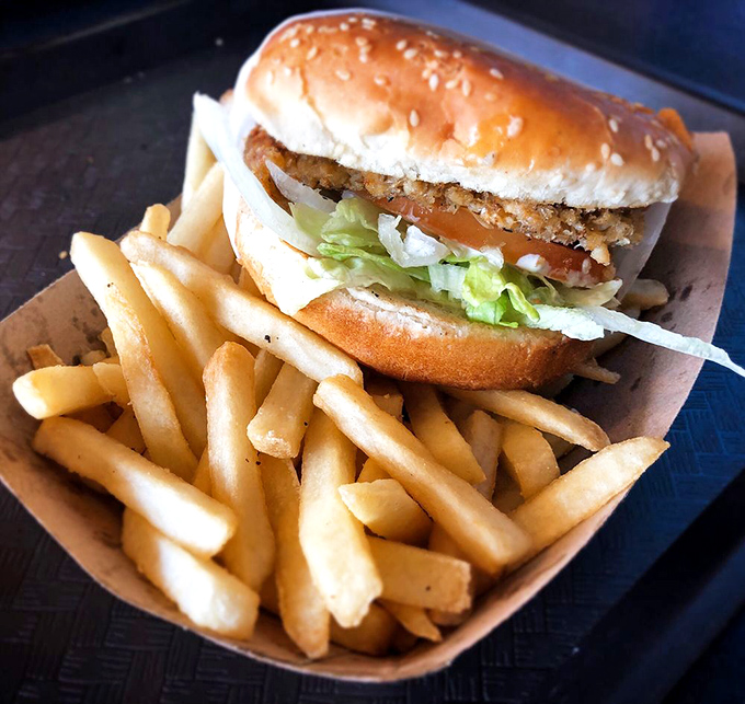 The classic fish sandwich and fries – proof that sometimes the simplest combinations are culinary poetry in a paper basket.