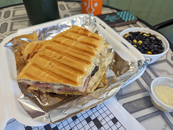 This pressed Cuban sandwich, golden and crispy, comes with black beans that aren't just a side dish—they're practically their own main event.
