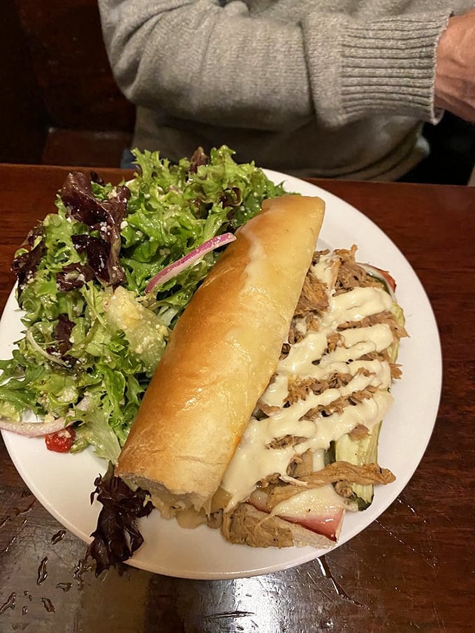 A Cuban sandwich that demands to be photographed before eaten. That melty cheese cascade is basically food paparazzi bait.