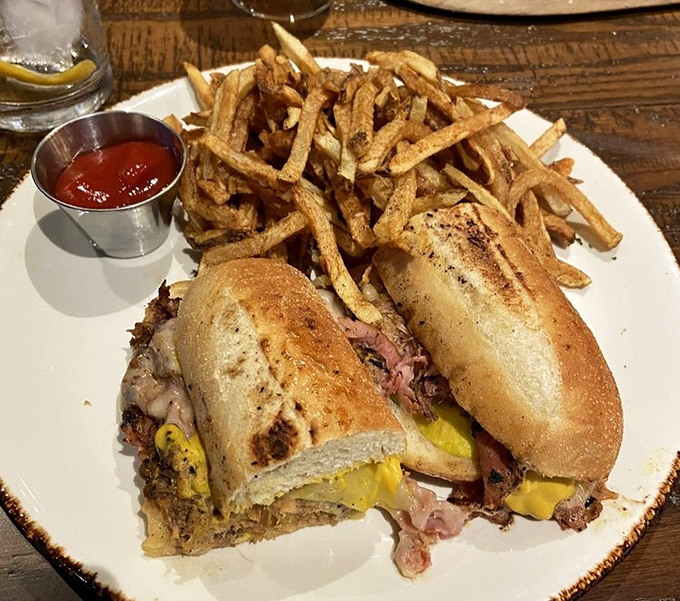 A proper Cubano with crispy fries – the kind of sandwich that makes you wonder why you ever settled for ordinary lunch options.
