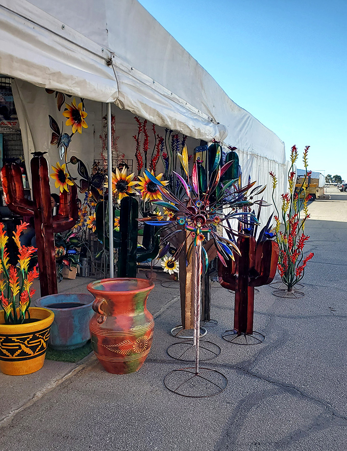 Metal cacti and colorful pottery bring desert charm home—garden art that thrives without watering in this vibrant vendor display.