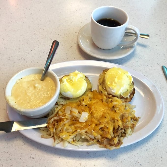 Breakfast architecture at its finest—perfectly poached eggs atop a foundation of hash browns, where every forkful delivers that satisfying morning harmony.