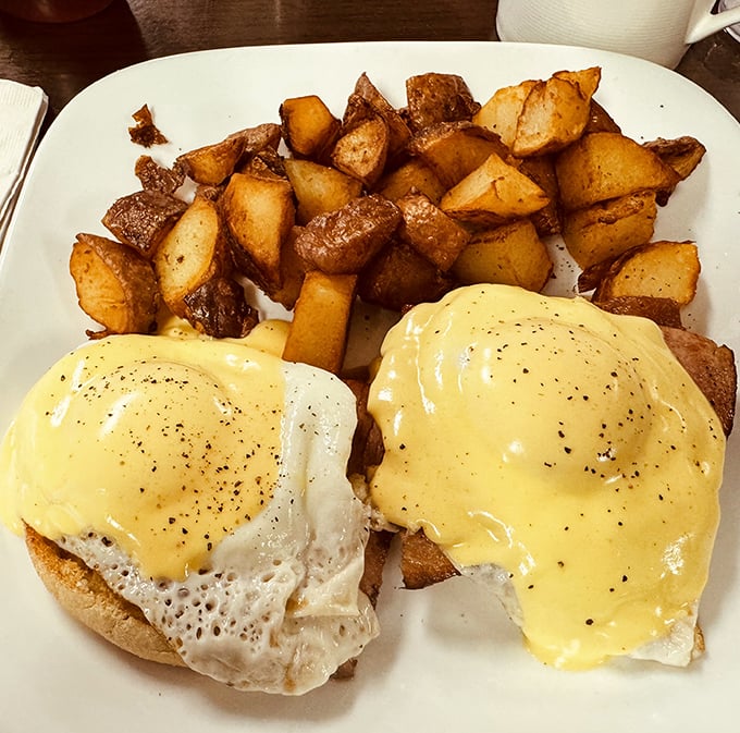 Eggs Benedict done right—perfectly poached eggs, velvety hollandaise, and home fries that deserve their own fan club.