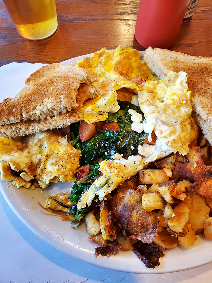 Breakfast of champions, not Instagram influencers – golden pancakes, sausage links, and a sunny-side egg that actually tastes like morning.
