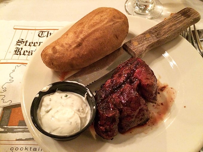 A steak knife with a wooden handle beside a perfectly cooked filet—this isn't just dinner, it's a ritual that deserves your full attention and empty stomach.