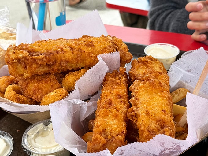 Golden fish and chips that crunch like autumn leaves reveal flaky perfection with every bite.