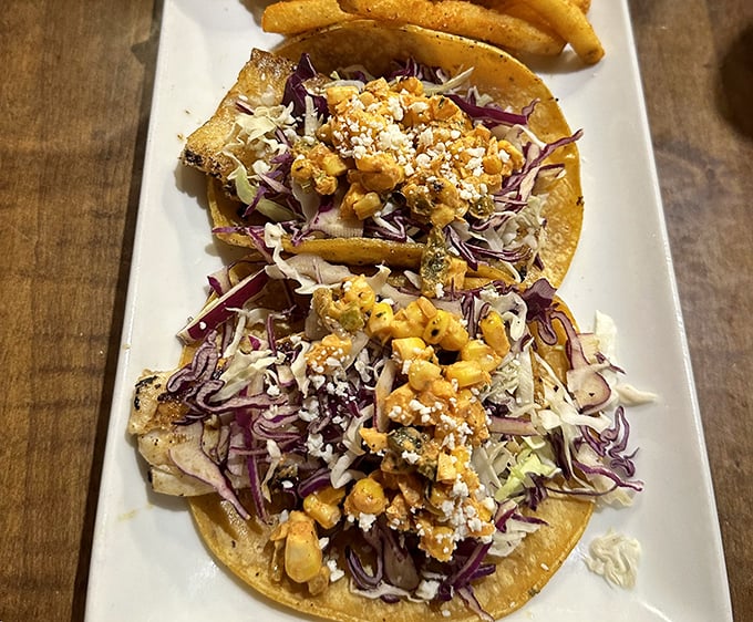 Fish tacos that make you question why you ever settled for lesser versions—vibrant slaw and crumbled cheese creating a perfect coastal symphony.