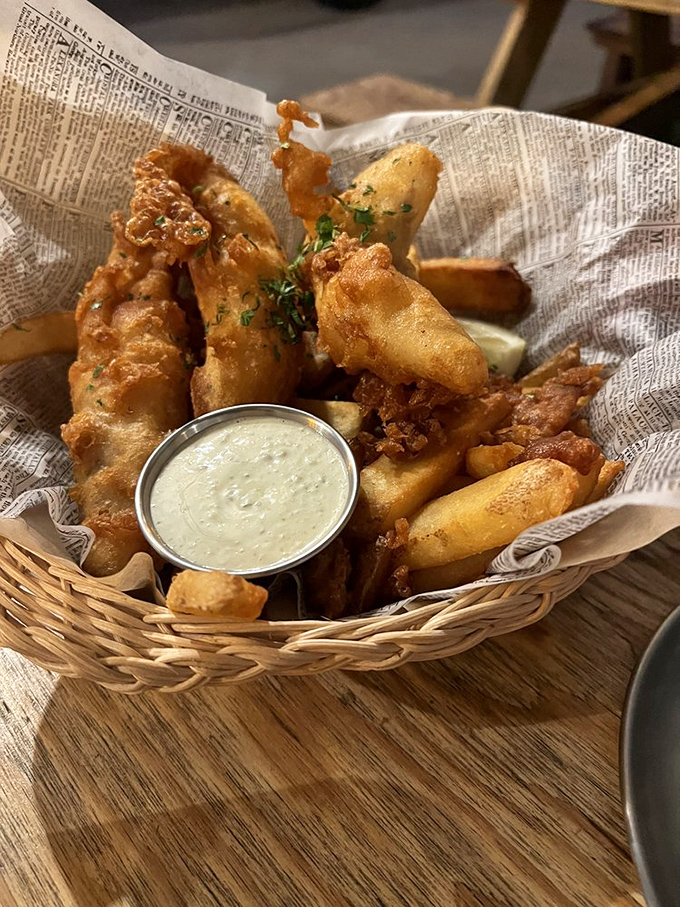 Fish and chips that would make London jealous – golden-battered perfection in a basket that whispers, "Diet? What diet?"