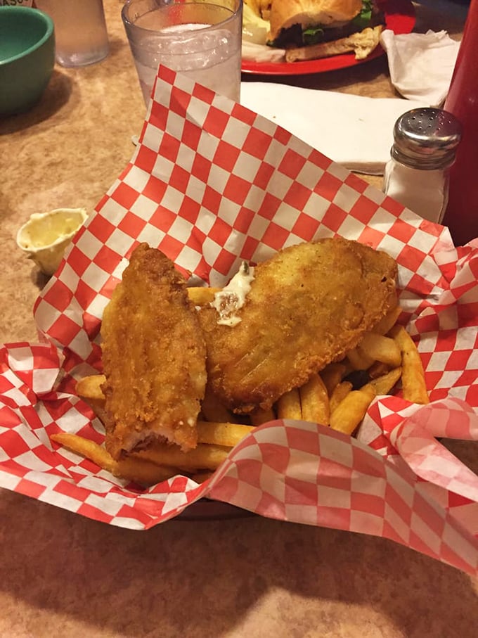 Fish and chips served in the classic red-checkered basket – crispy, golden comfort that tastes like vacation even on a Tuesday afternoon.