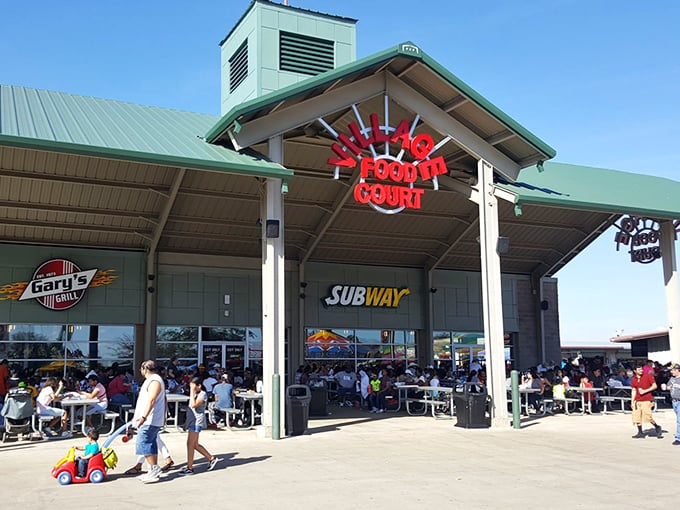 The food court: where shopping stamina gets replenished and diet resolutions go to die beneath the Texas sun.