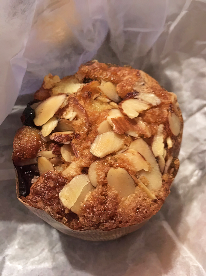 This almond-topped muffin isn't just breakfast—it's edible architecture with those perfectly placed slivers creating a delicious roof.