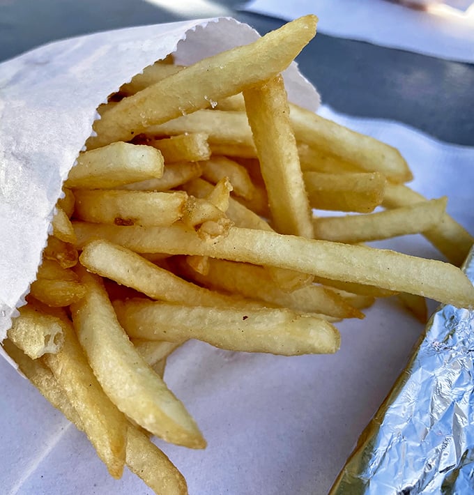 Golden fries that achieve that perfect balance – crisp exterior giving way to fluffy potato within. The kind that make you protective of your basket when friends ask for "just one."