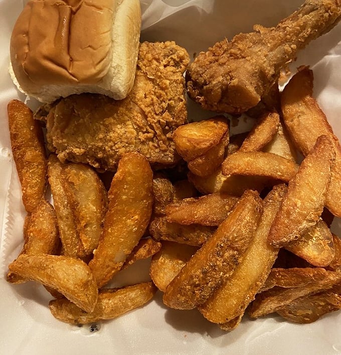 The holy trinity of comfort: golden fries, crispy chicken, and a soft roll standing by. This isn't a meal—it's a warm hug on a plate.