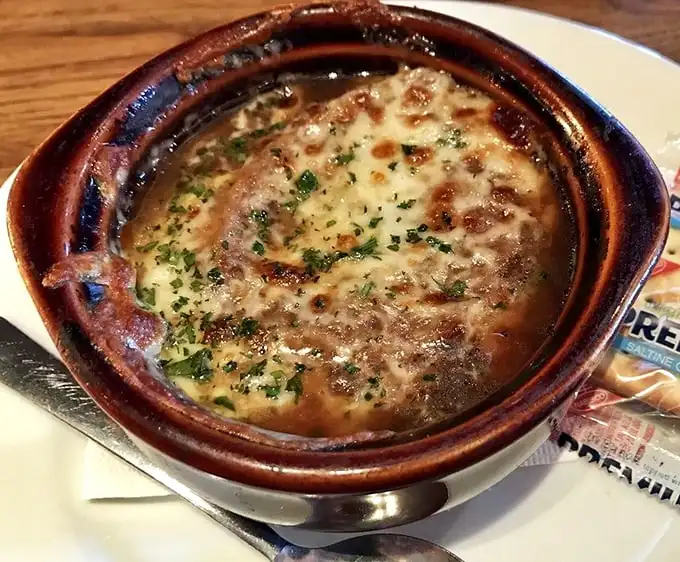 French onion soup that's achieved the perfect cheese-to-broth ratio – that magical moment when your spoon breaks through the melty canopy into savory bliss below.