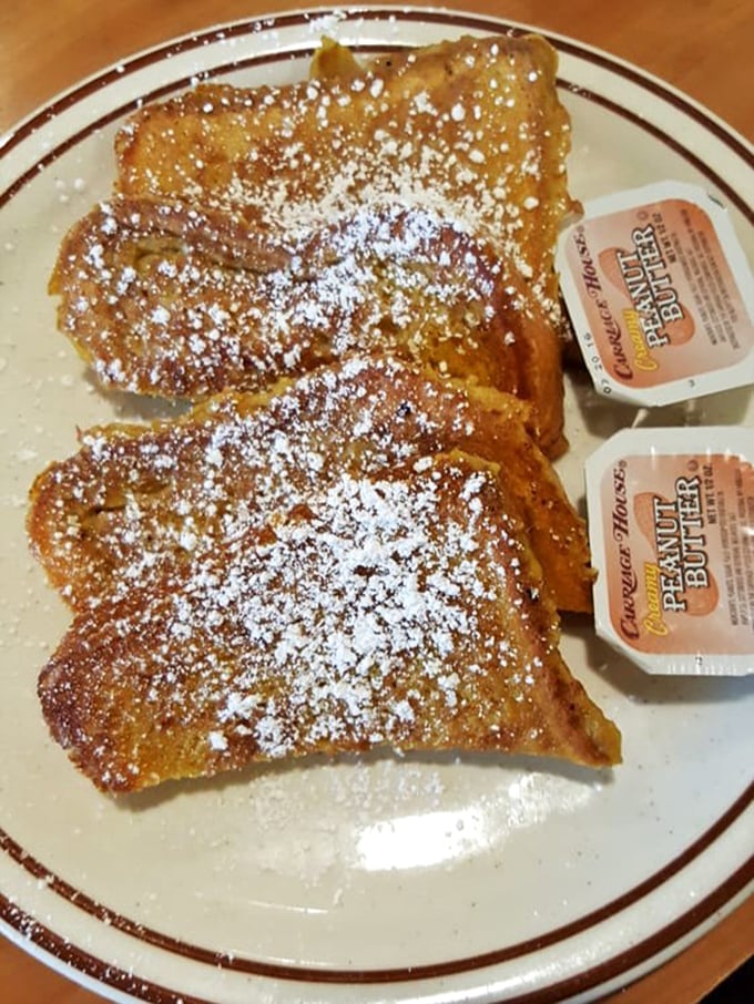French toast that's been dunked, griddled, and powdered to perfection. Those little butter packets are about to experience their finest moment.