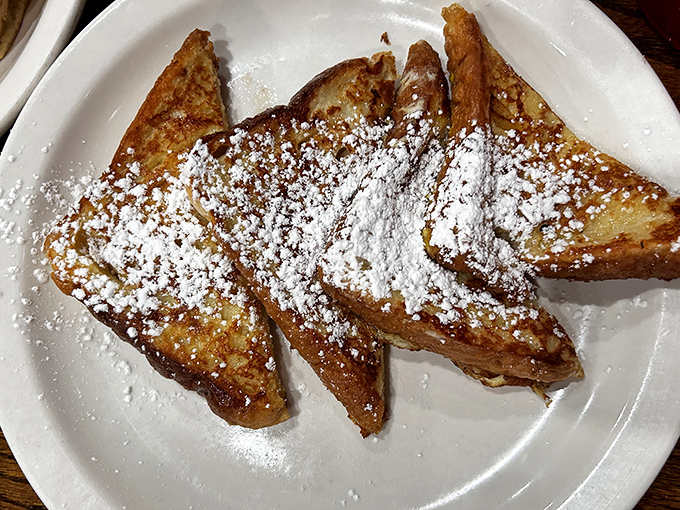 French toast dusted with powdered sugar like the first snow of winter. Crisp edges, custardy center – breakfast's perfect middle ground.