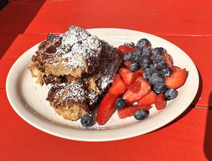French toast that's had a proper spa treatment—powdered sugar dusting, fresh berries, and enough decadence to make Monday morning feel like Saturday.