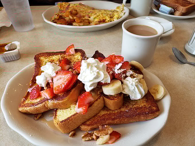 The French Toast Napoleon isn't just breakfast, it's architecture. Layers of toast, fresh strawberries, bananas, and whipped cream create a morning masterpiece.