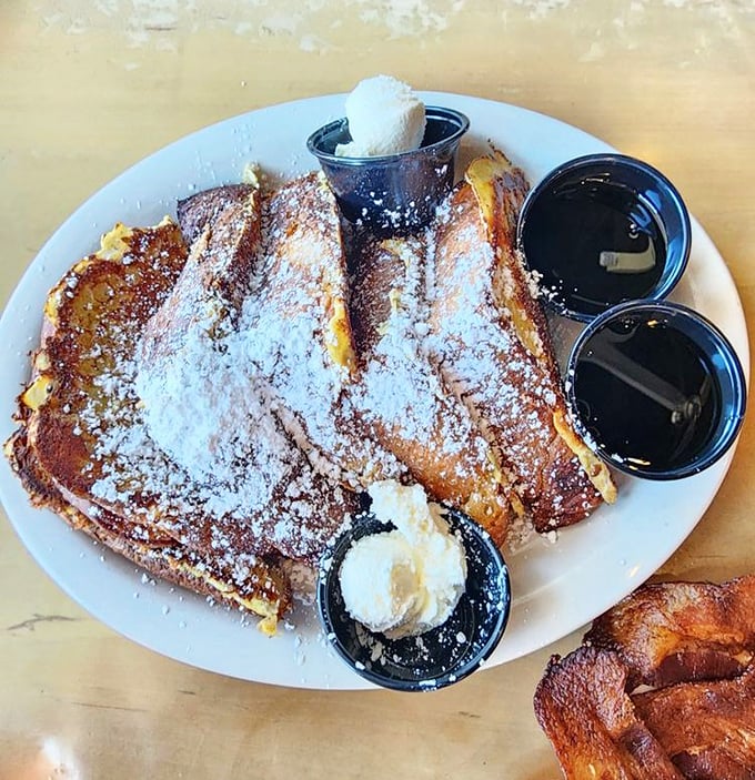 French toast that's achieved the impossible dream: perfectly crisp exterior giving way to custardy interior. The powdered sugar snowfall is just showing off.