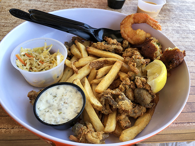 A seafood platter that brings the ocean to your table—crispy, golden treasures from the deep paired with fries that stay miraculously crisp.