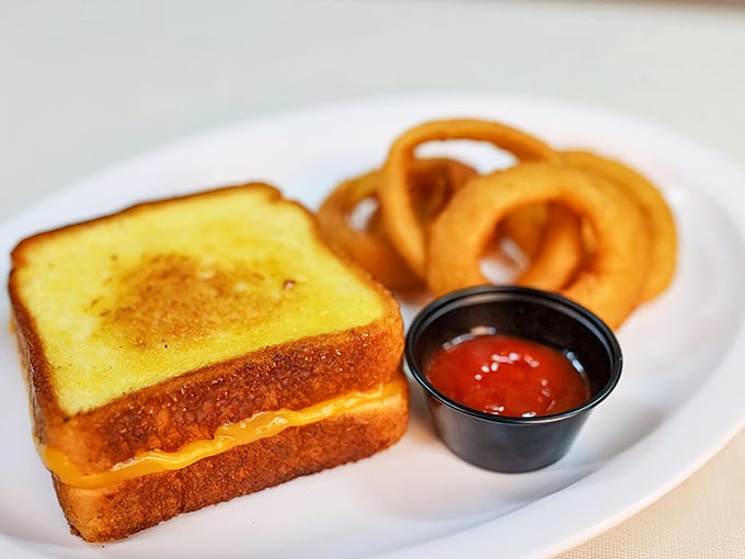Golden, crispy, gooey perfection on a plate. This grilled cheese has clearly been to finishing school—and graduated with honors.