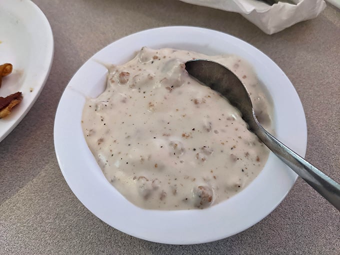 Creamy grits with perfectly cooked bacon showcase the kind of Southern comfort that makes mornings feel like celebrations.