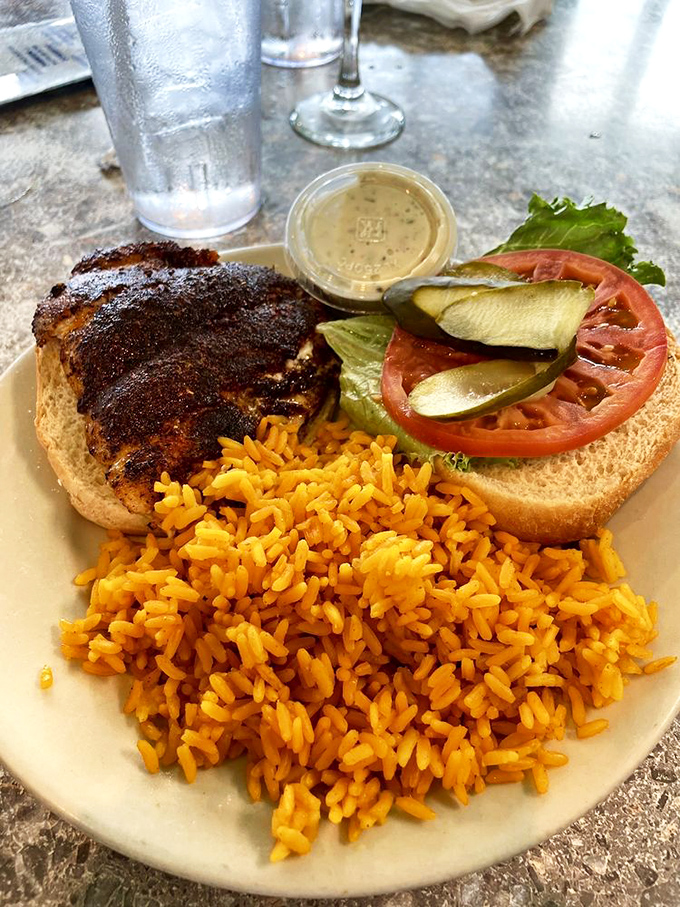 The legendary blackened grouper sandwich—where the fish-to-bread ratio finally favors the fish. Yellow rice never had a better companion.