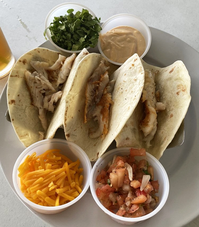 Fish tacos done right—simple, fresh, and accompanied by all the fixings. The perfect handheld vacation for your taste buds.