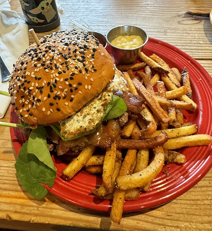 This isn't just a burger—it's an architectural marvel of sesame-studded bun, perfectly seared patty, and fresh greens that somehow manages to stay together until the last bite.