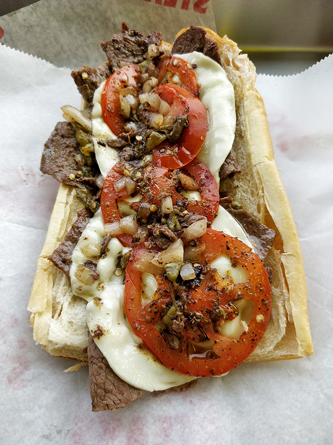 When steak, tomato, and melty cheese come together, it’s magic — a religious experience with hoagie architecture that could make Frank Gehry jealous.