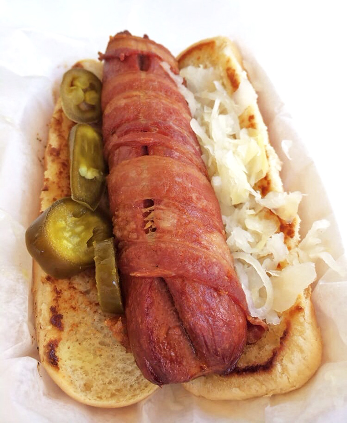 A hot dog that got all dressed up for its Key West vacation – complete with sauerkraut accessories and a tan that would make George Hamilton jealous.