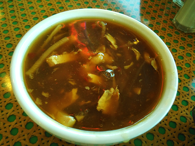 Hot and sour soup that dances on your tongue—a complex performance of flavors in a humble ceramic bowl.