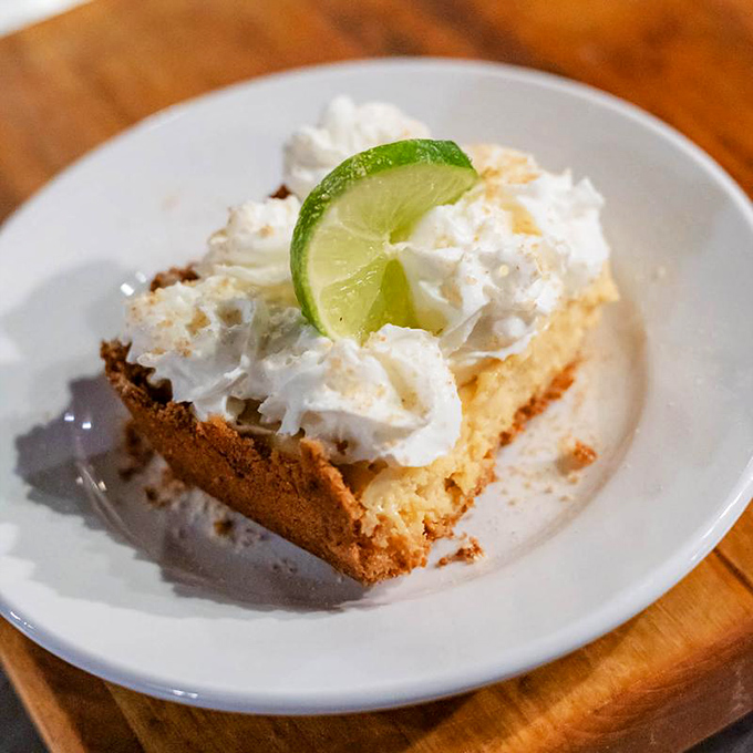 Key lime pie that strikes the perfect balance between tart and sweet—topped with enough whipped cream to make your cardiologist wince approvingly.